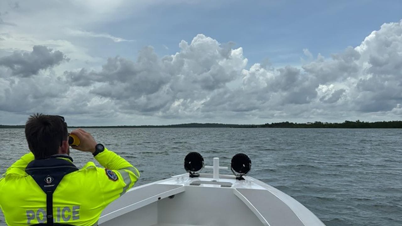 Divers brave crocs in search for body seen in water